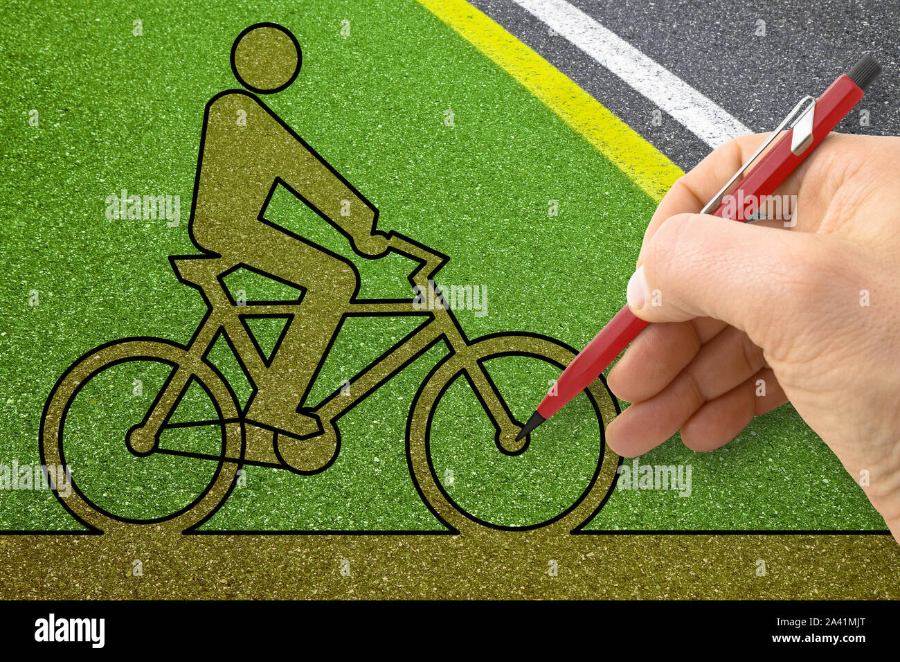 Hand drawing a bicycle silhouette on a green asphalt bicycle lane ...