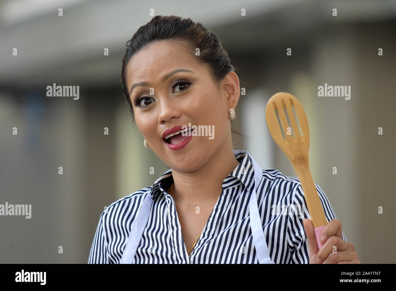 Female Cook And Happiness With Kitchen Utensils Stock Photo - Alamy