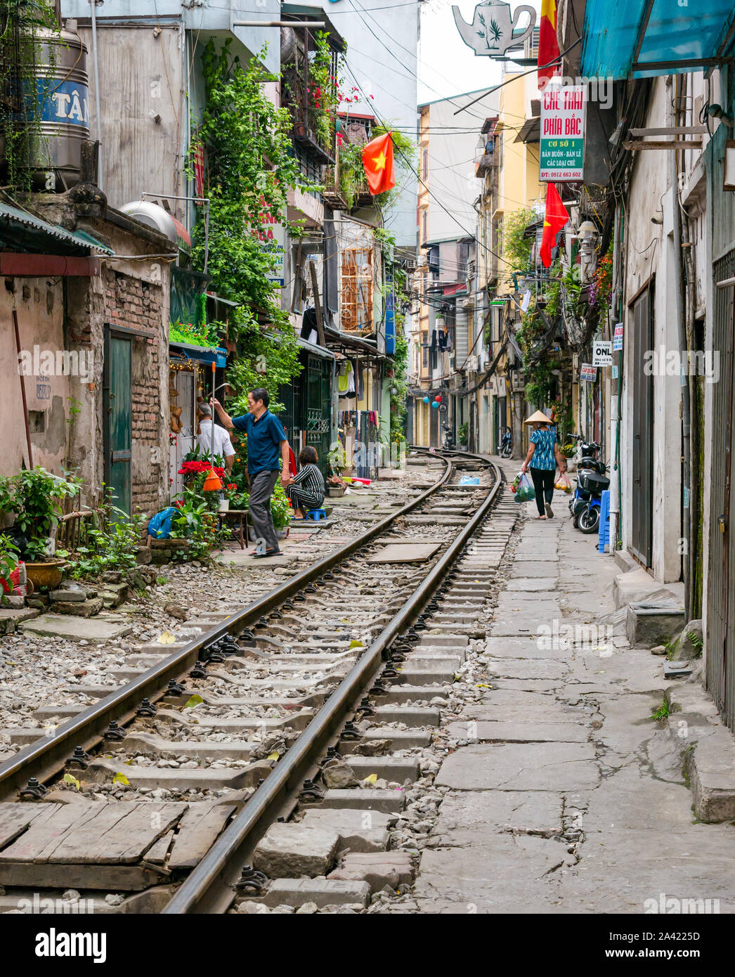 Railway village or Train Street, narrow lane with railway line next to ...