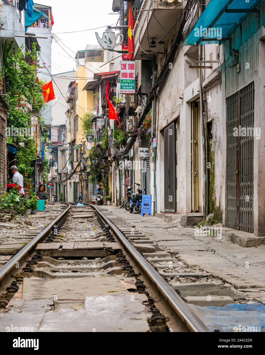 Railway village narrow lane with railway line next to old houses, Hanoi ...