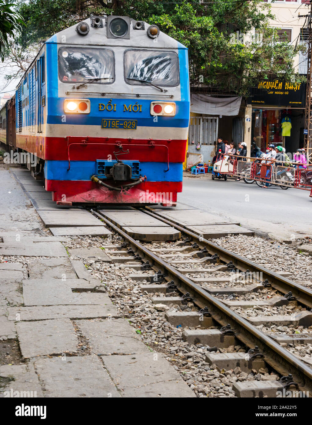 Train crossing road on tracks at Hanoi railway village or Train Street ...