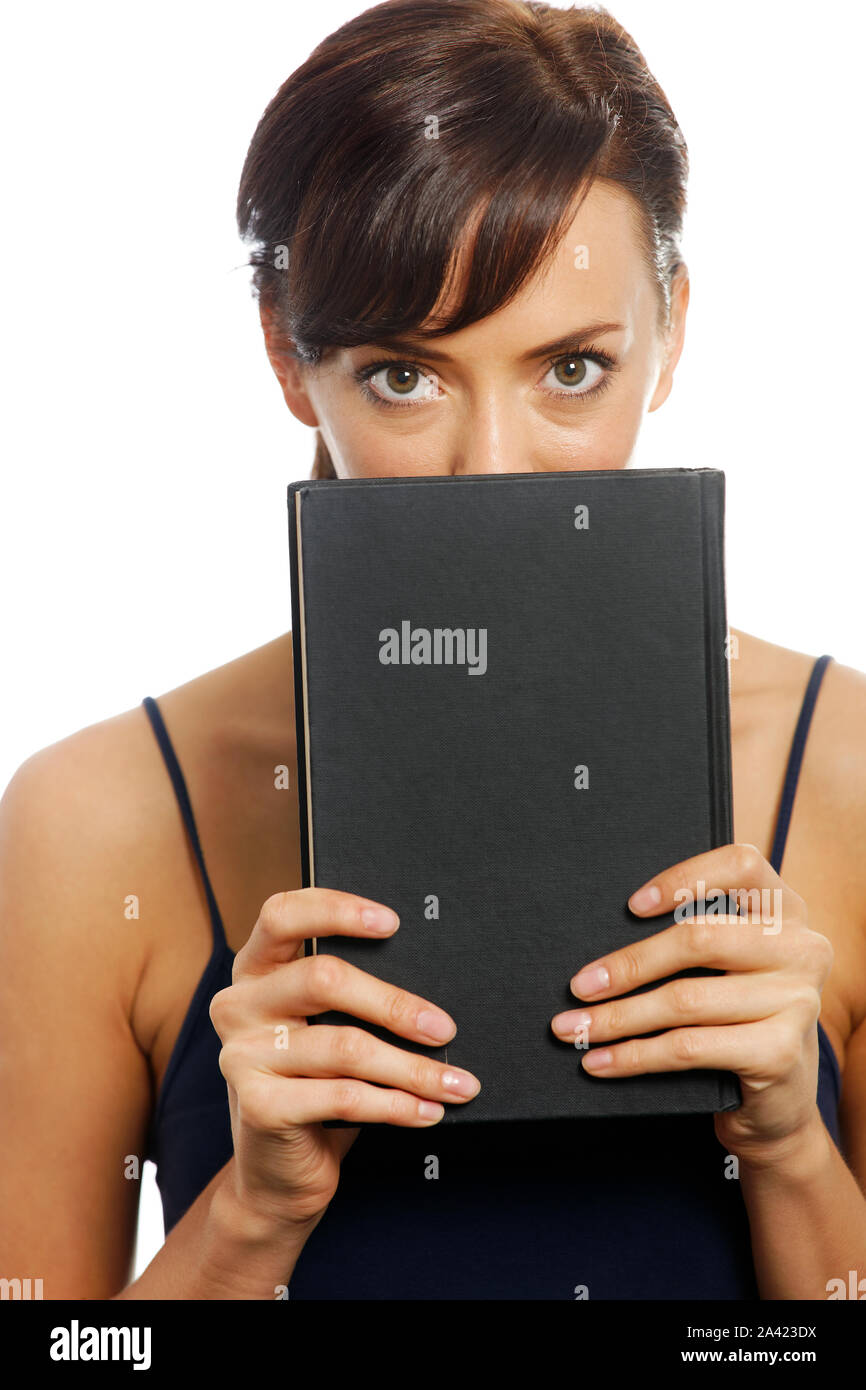 Woman holding a book over face hi-res stock photography and images - Alamy