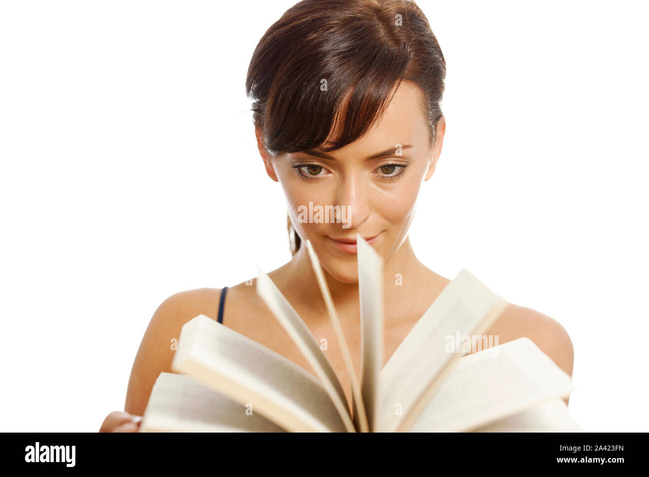 Young woman flicking through the pages of a book Stock Photo - Alamy