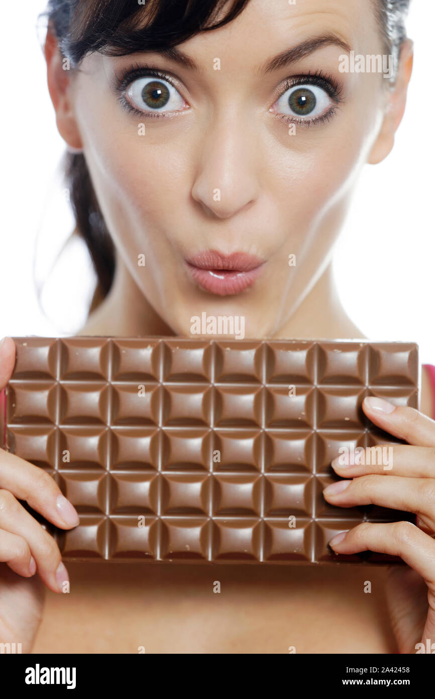 Young woman eating a huge chocolate bar Stock Photo - Alamy