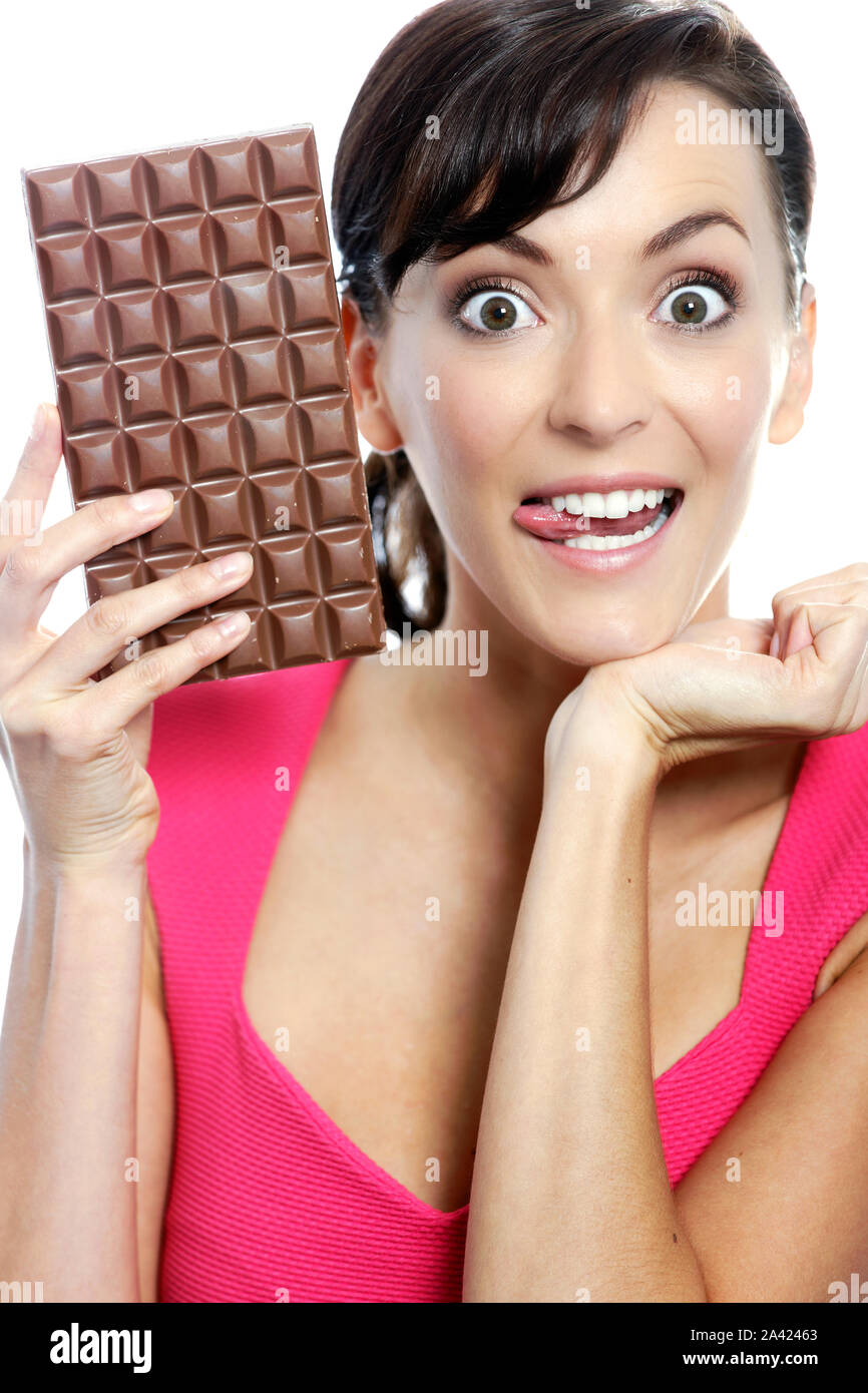Young woman eating a huge chocolate bar Stock Photo - Alamy