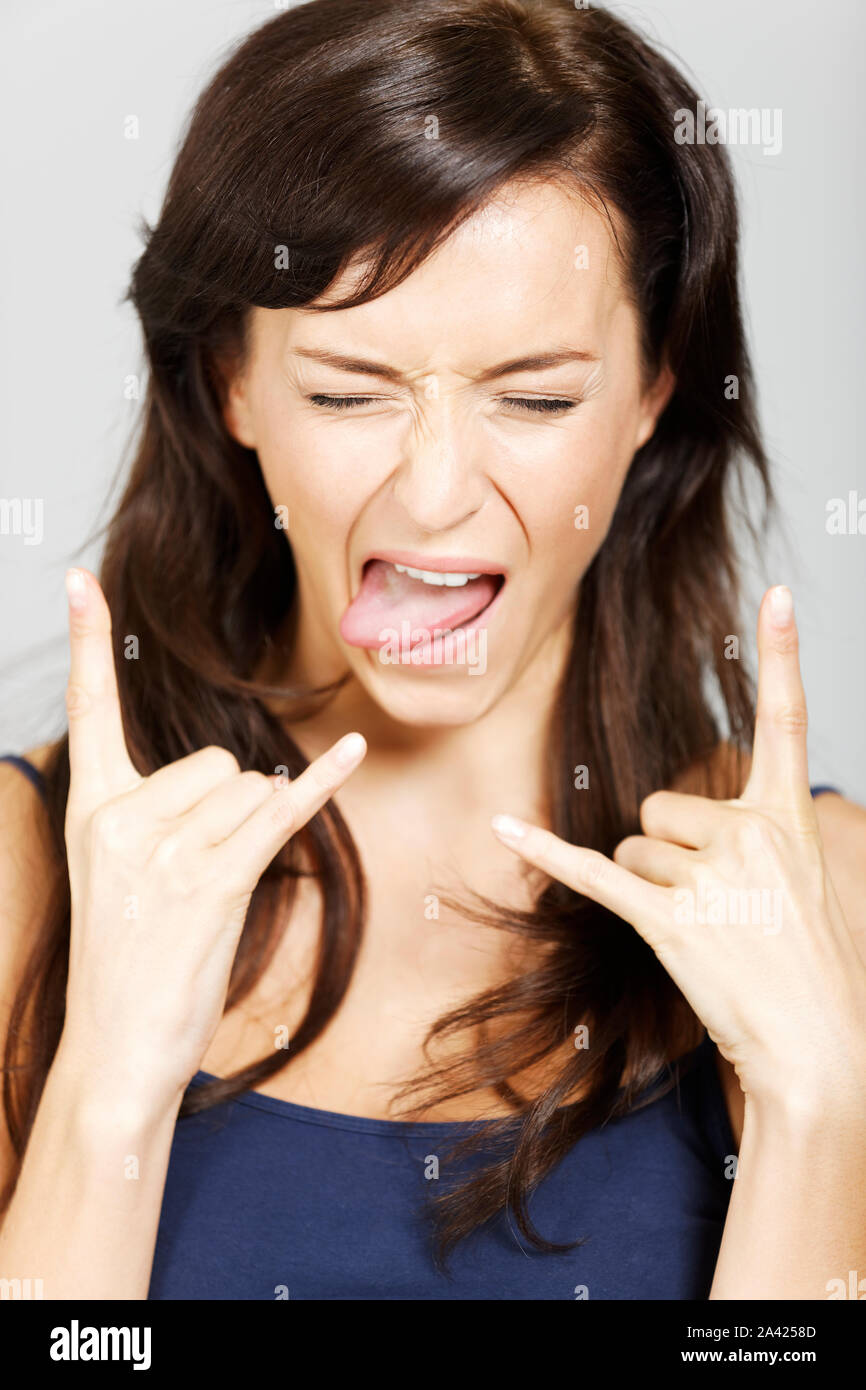 Young woman pulling a wacky face expression Stock Photo - Alamy