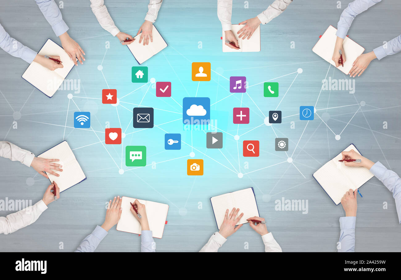 Group of people with devices in hands working in team on tablets ...