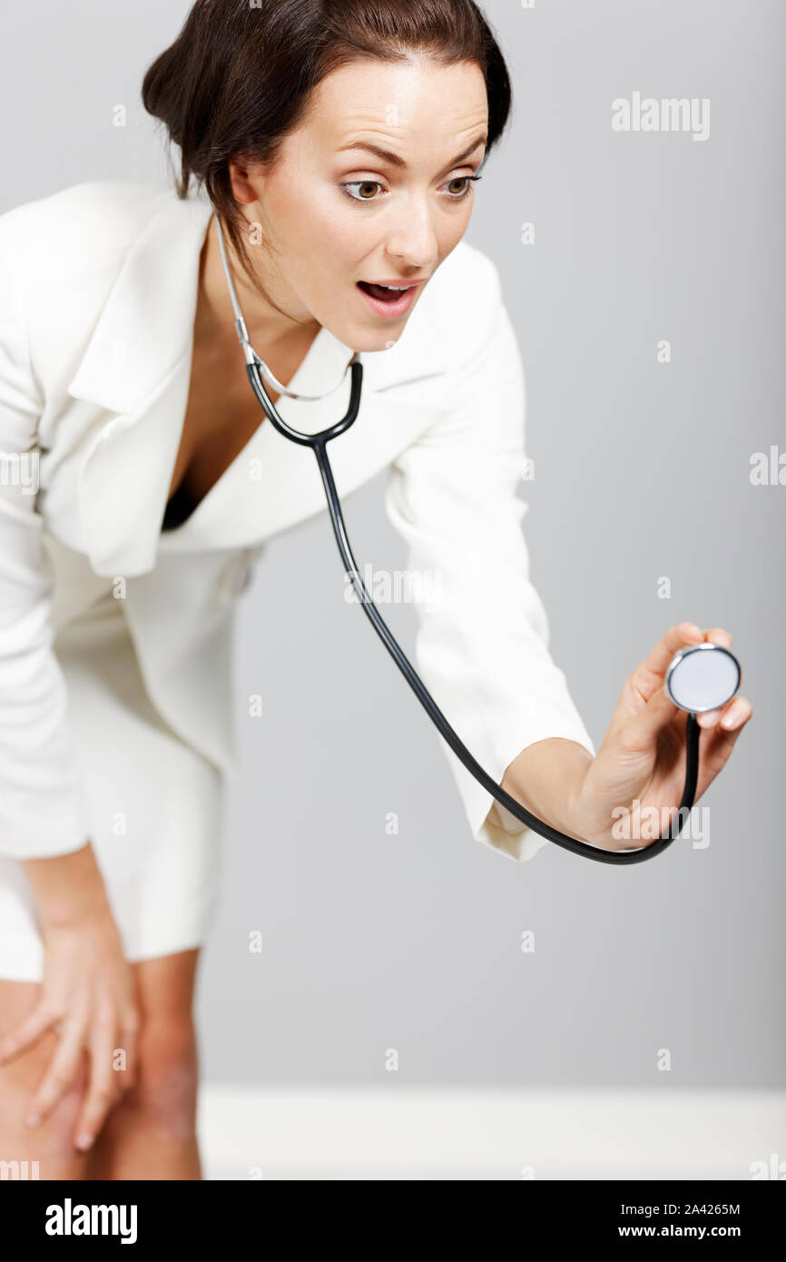 Helpful young doctor with stethoscope Stock Photo - Alamy