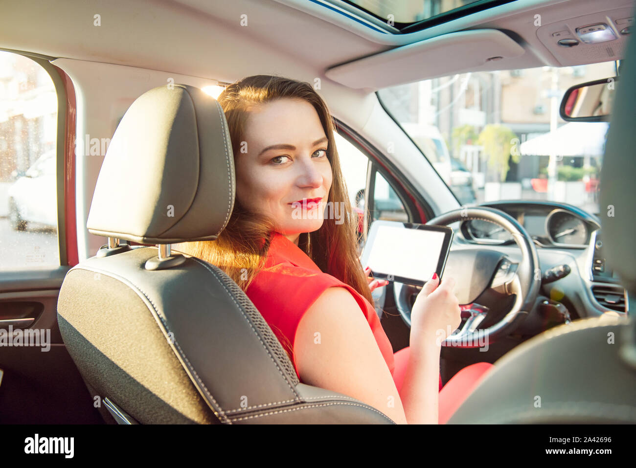 Back view Portrait of smiling caucasian young woman driver looking at ...