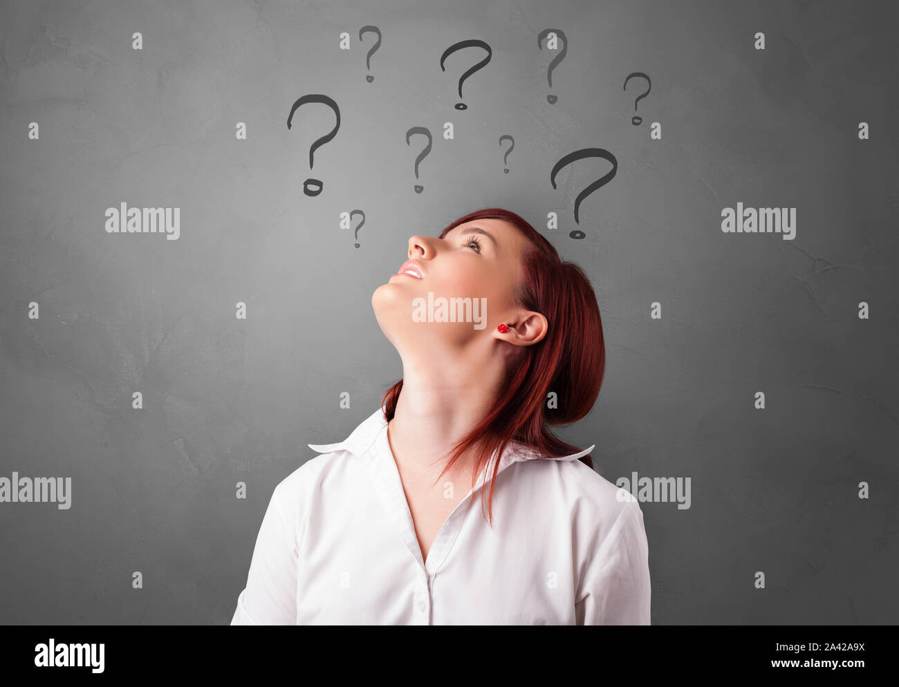 Person with question marks around face Stock Photo - Alamy