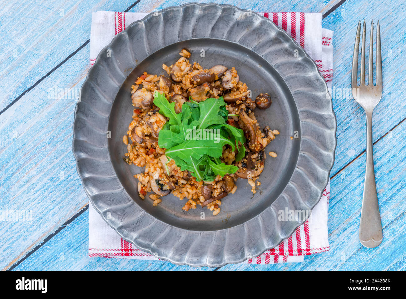 Mushroom, chorizo and thyme risotto with rocket lettuce - overhead view ...