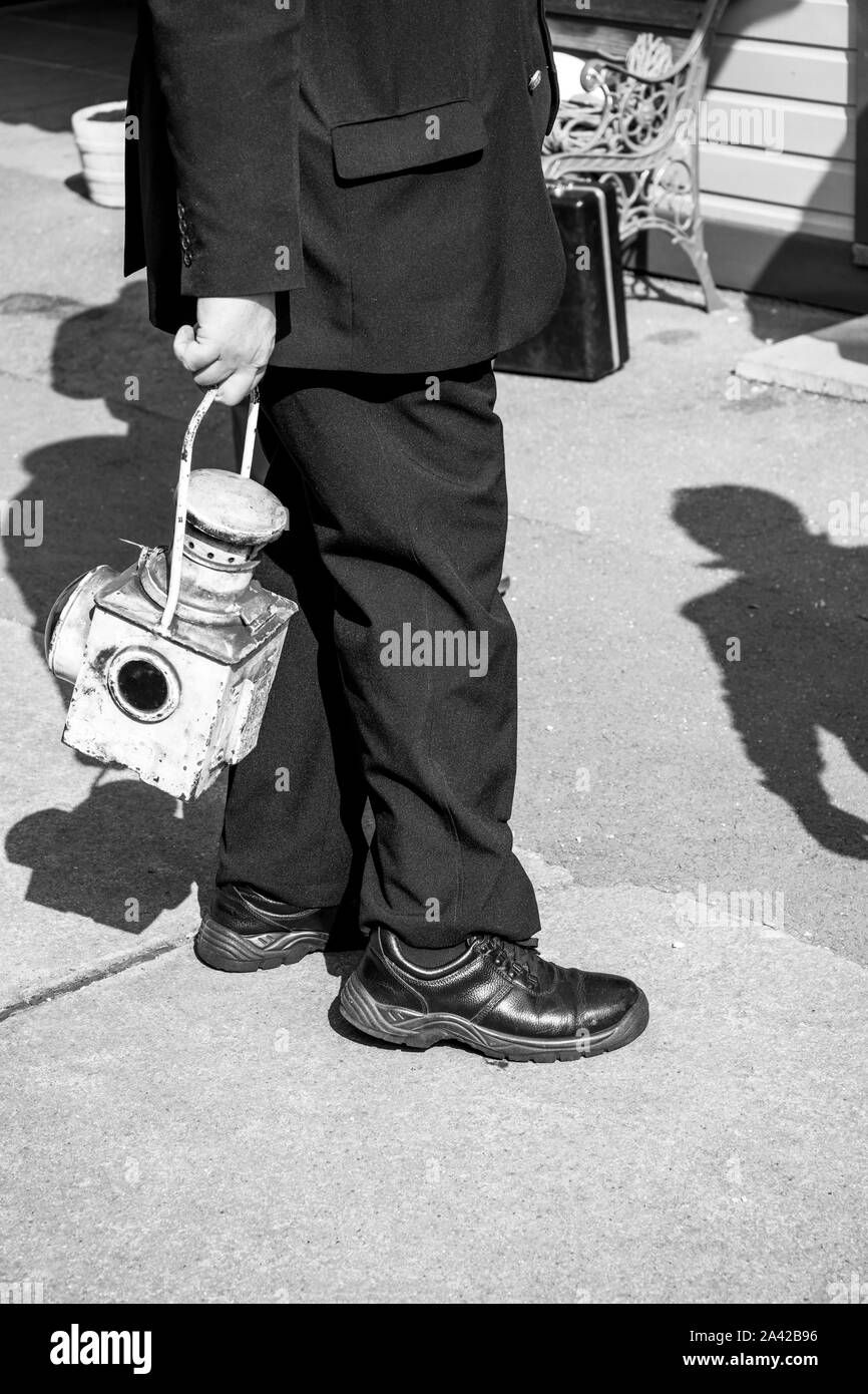 Staff carry a oil lamp at the station Stock Photo - Alamy