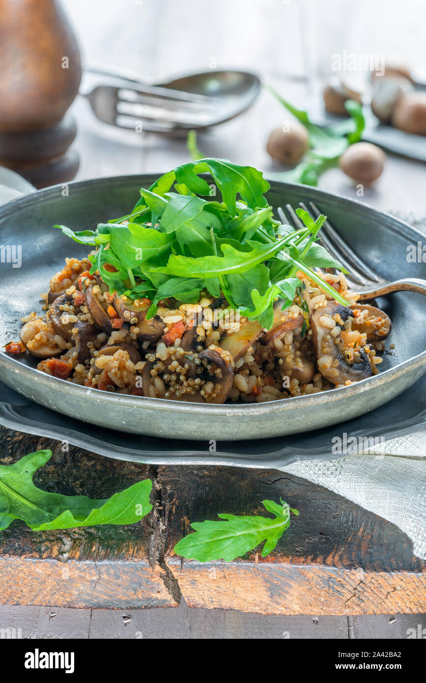 Mushroom, chorizo and thyme risotto with rocket lettuce Stock Photo - Alamy