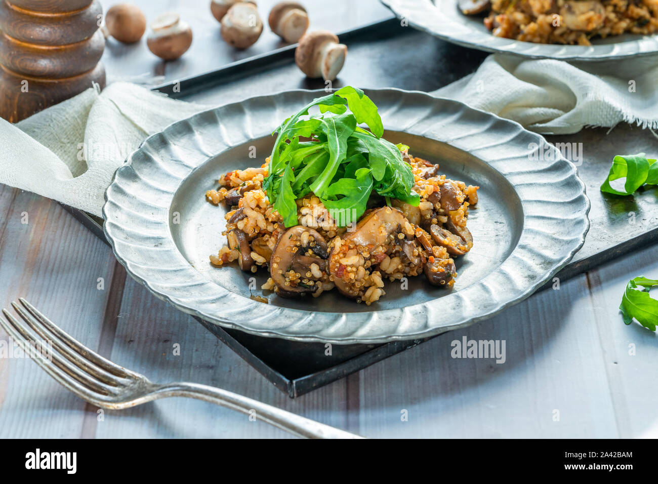 Mushroom, chorizo and thyme risotto with rocket lettuce Stock Photo - Alamy