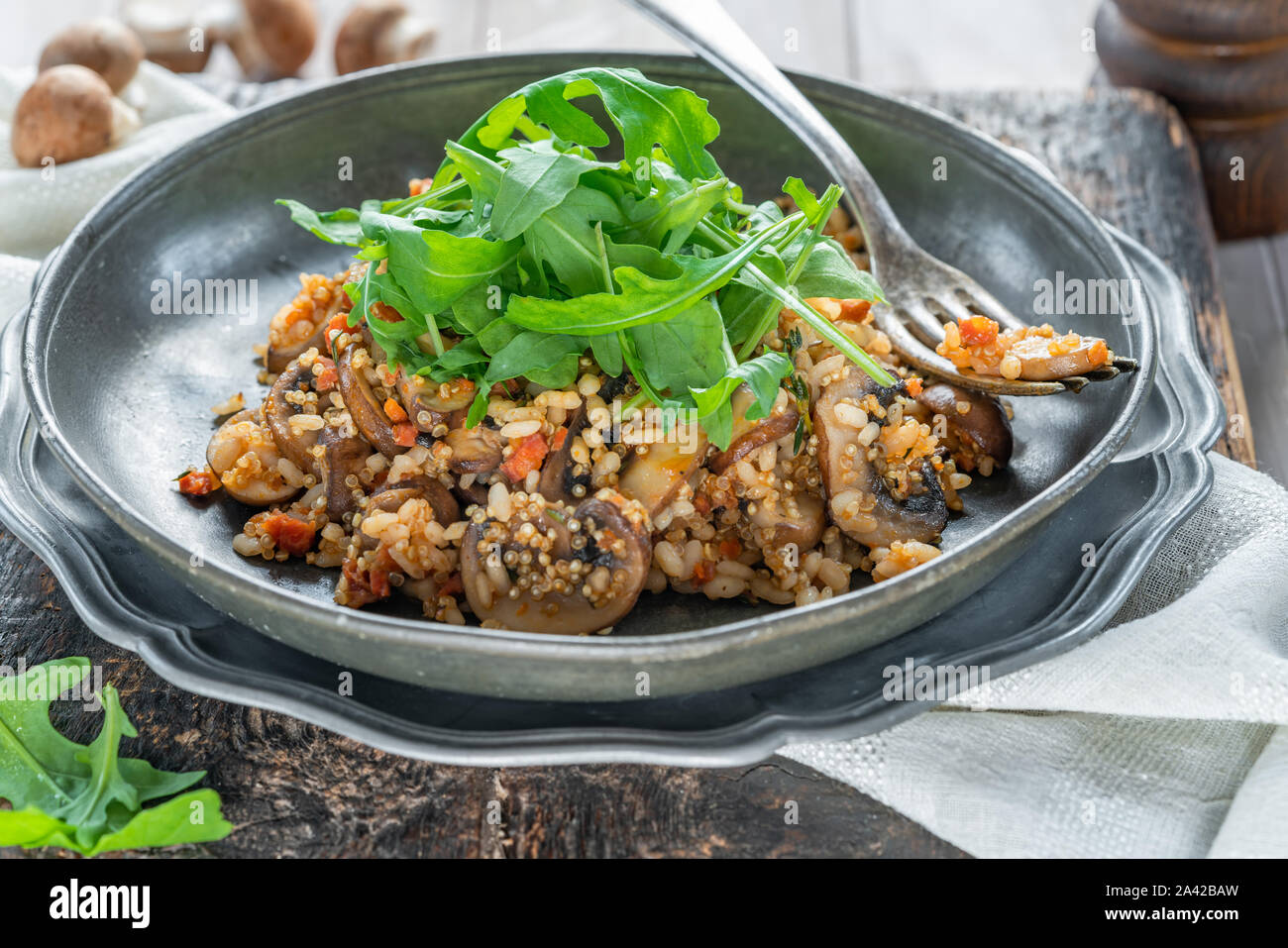 Mushroom, chorizo and thyme risotto with rocket lettuce Stock Photo - Alamy