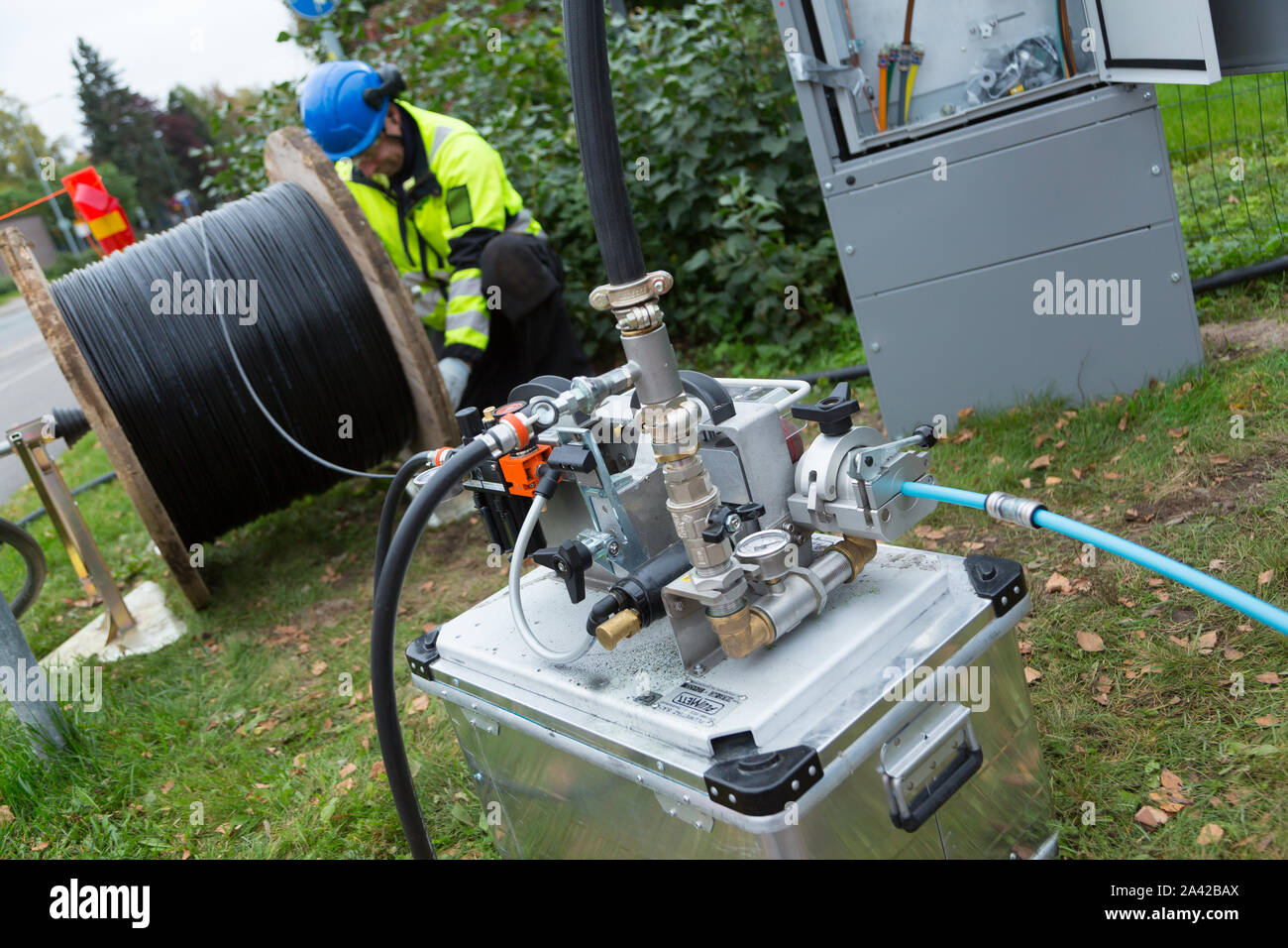 Man installing optical fiber cable for ultra fast internet connection ...