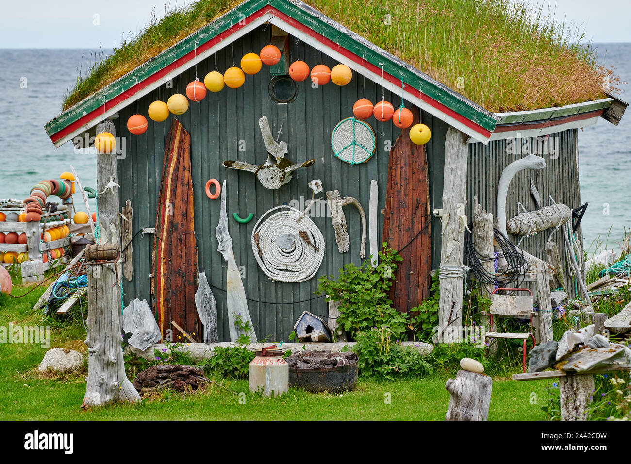 with whale bones and buoys decorated hut on the sea, Andenes, Norway ...