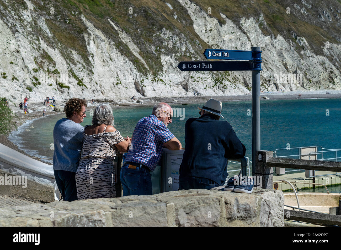 A happy group of family and friends enjoying the sunshine at Lulworth ...