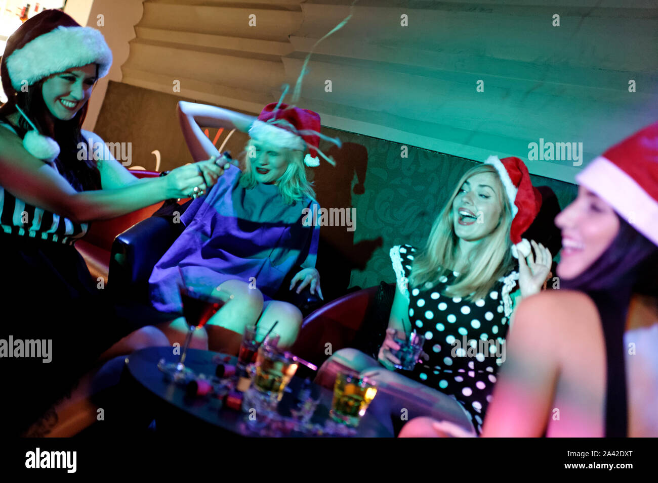 Attractive group of friends laughing and having fun at a Christmas ...