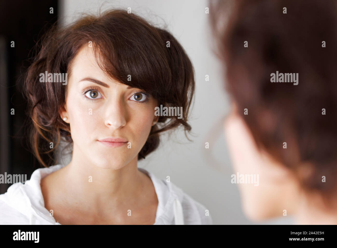Beautiful young woman's reflection in mirror Stock Photo - Alamy