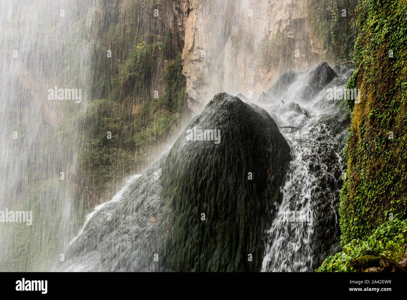 Water flushing on the stones with a lot of moss in the Huangguoshu ...