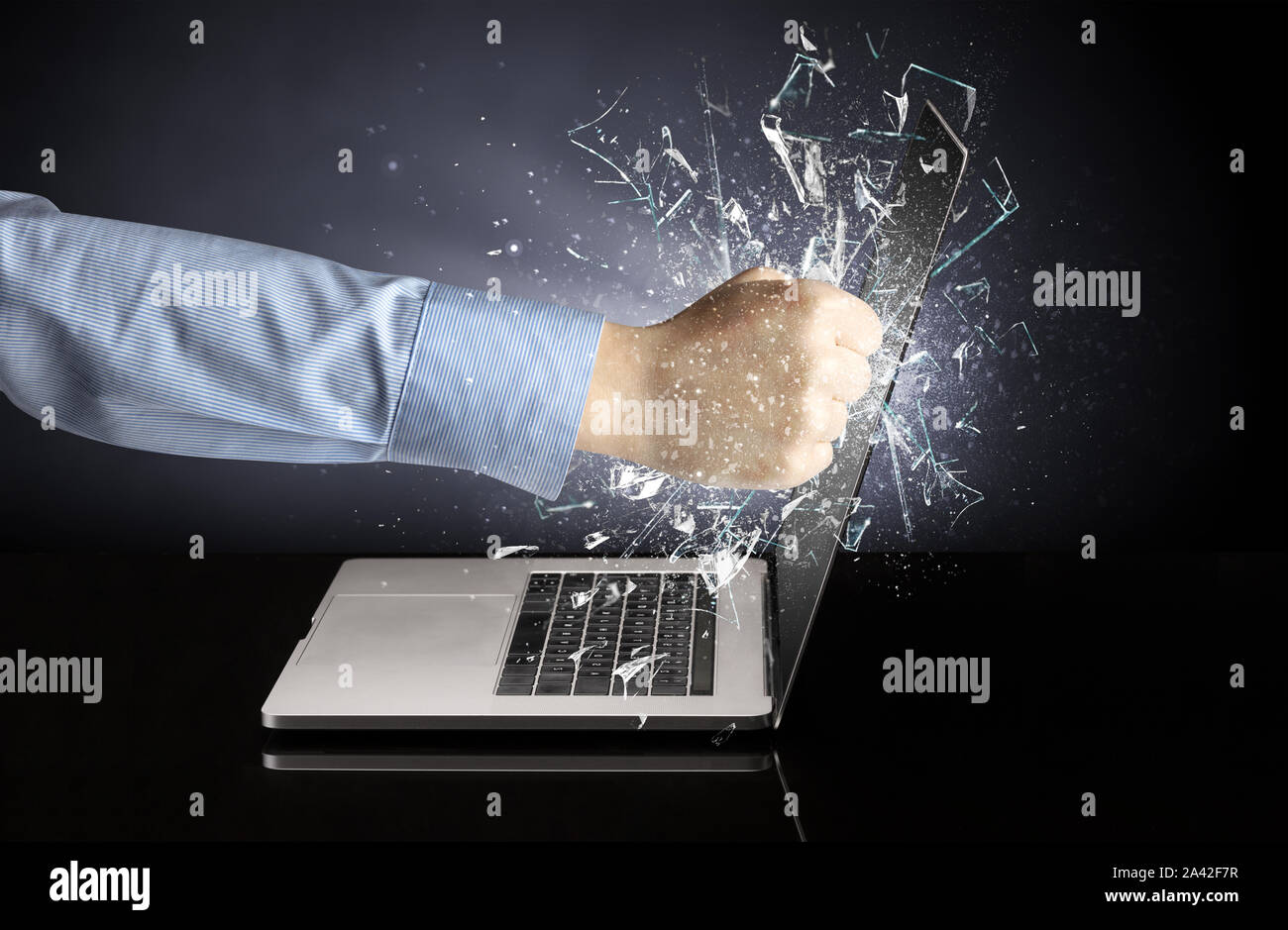 Hand hitting strongly laptop screen glass Stock Photo - Alamy