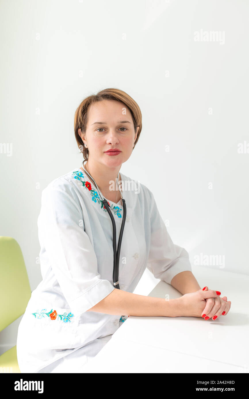 portrait of a young woman professional doctor with short haircut, in a ...