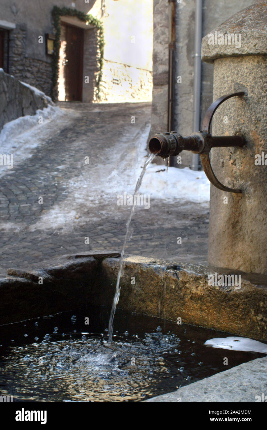 Ancient stone drinking fountain of fresh mountain water Stock Photo - Alamy