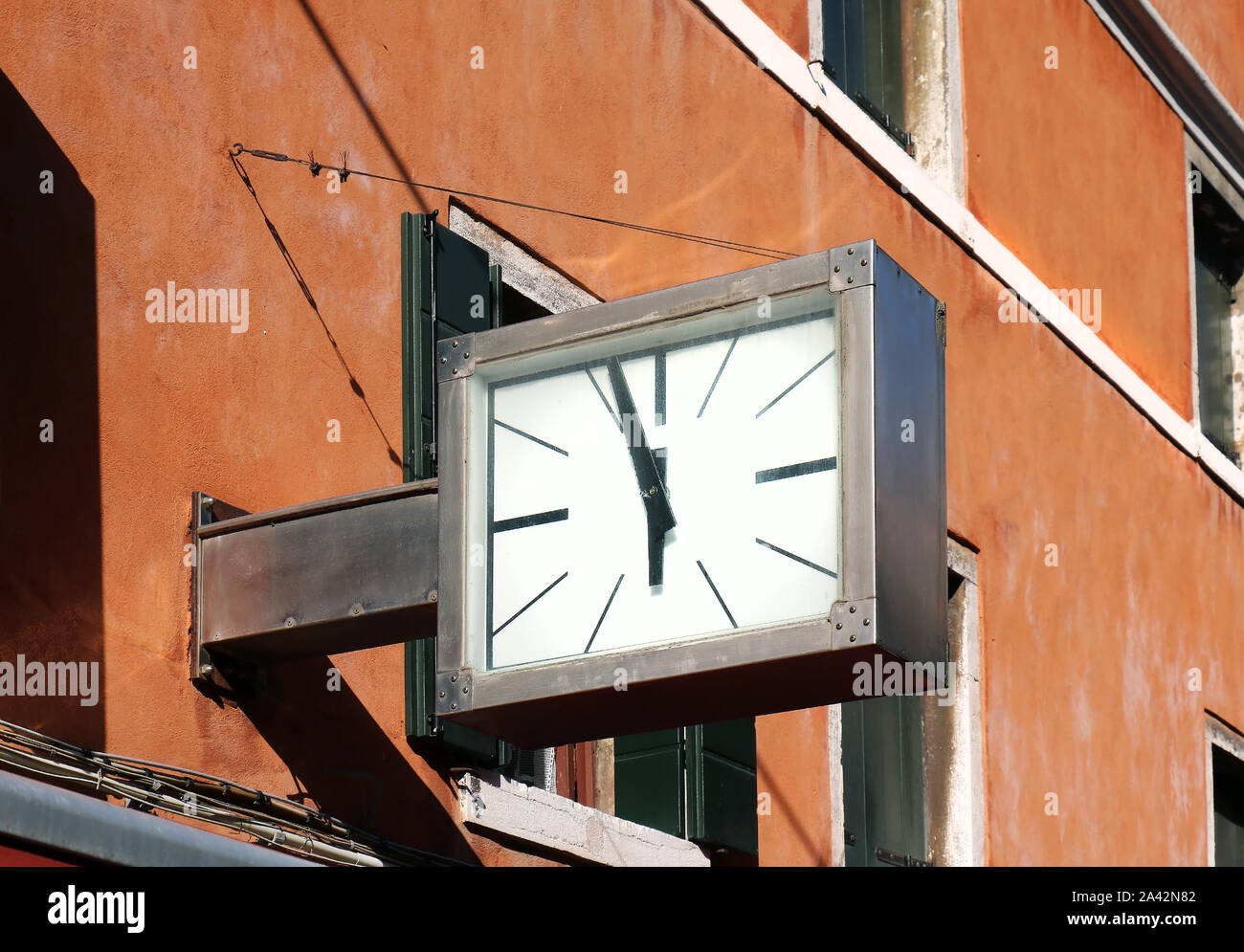 Retro square clock on old public building facade Stock Photo - Alamy