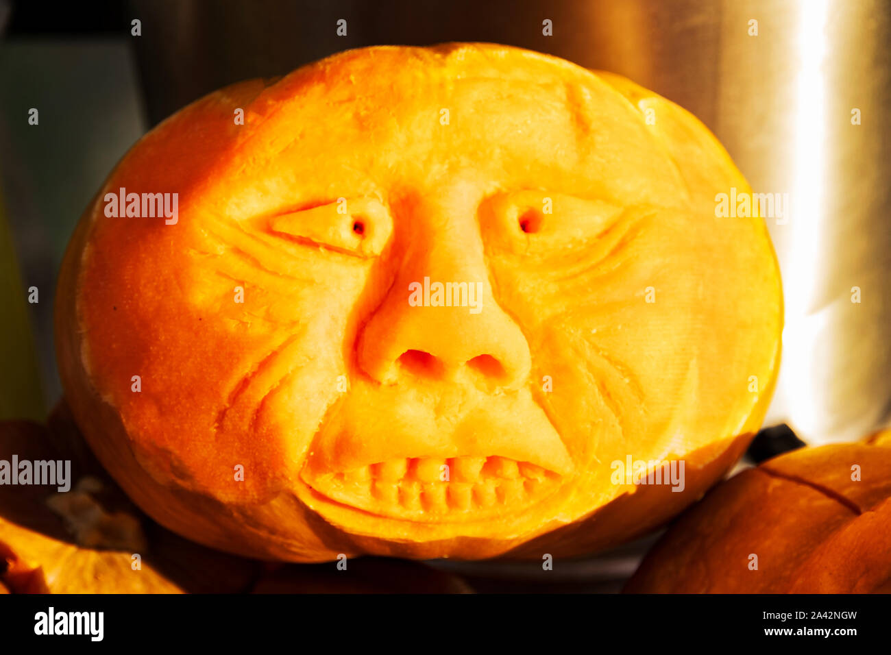 Vegetable carving. Halloween symbol. A scary face carved on a pumpkin ...