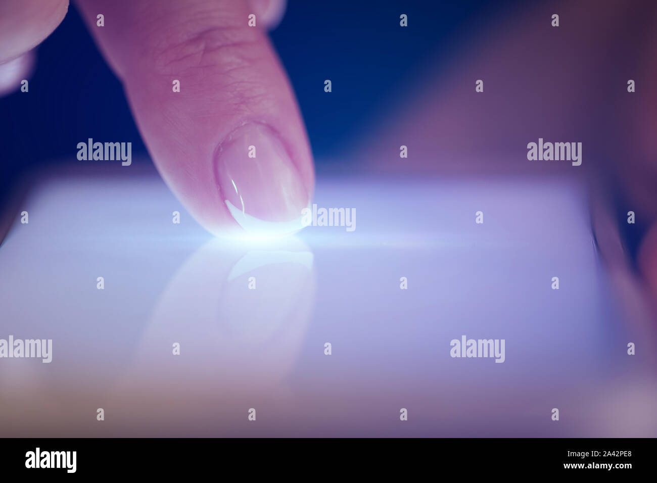 Finger touching phone with dark background with copyspace Stock Photo ...