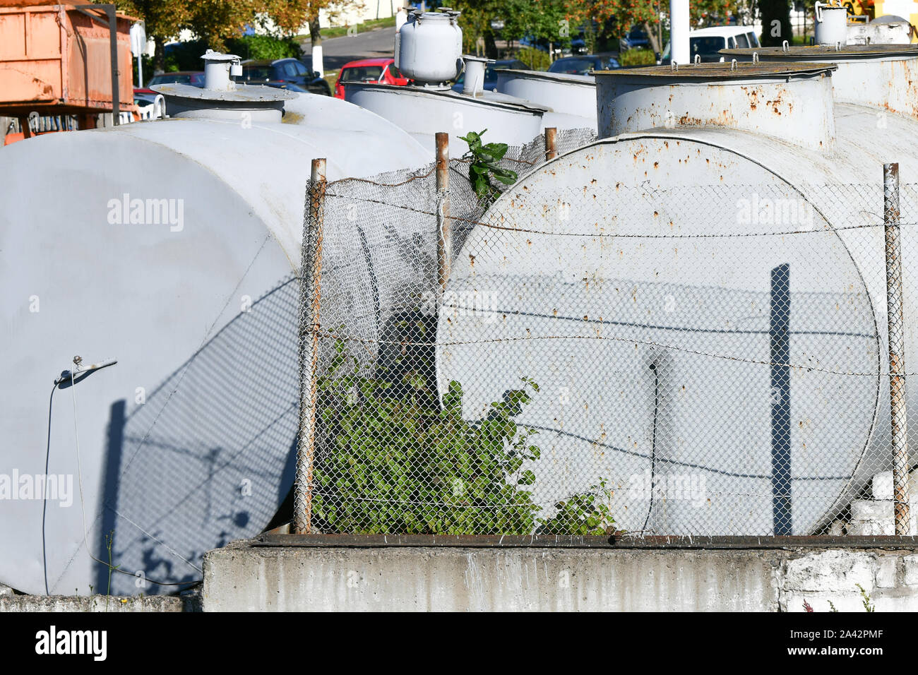 Old rusty fuel tanks in the yard. Clear sunny summer day abandoned old ...