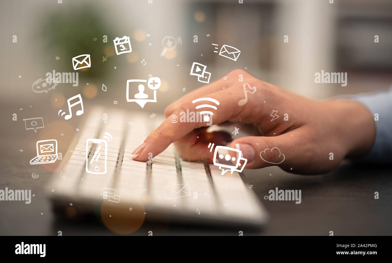 Business woman hand typing on keyboard with drawn application icons ...