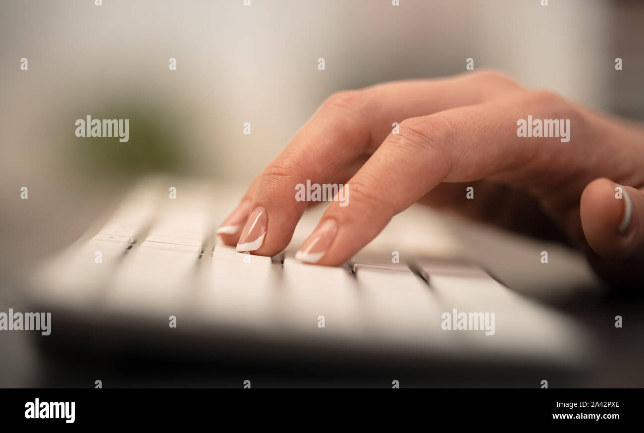Hand typing on keyboard with office concept Stock Photo - Alamy