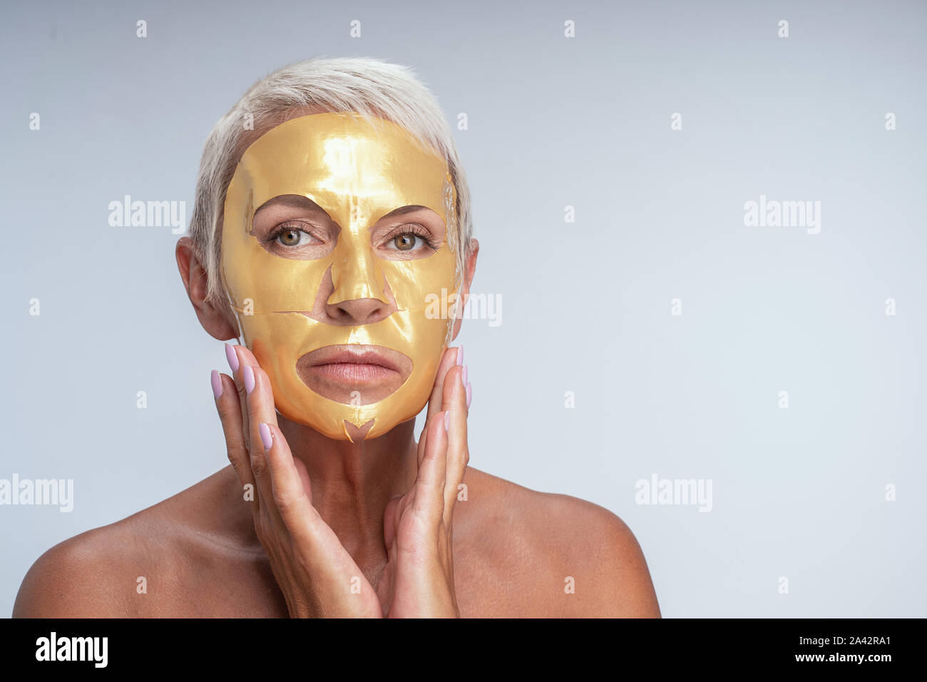 Kind female person standing isolated on white background and looking ...