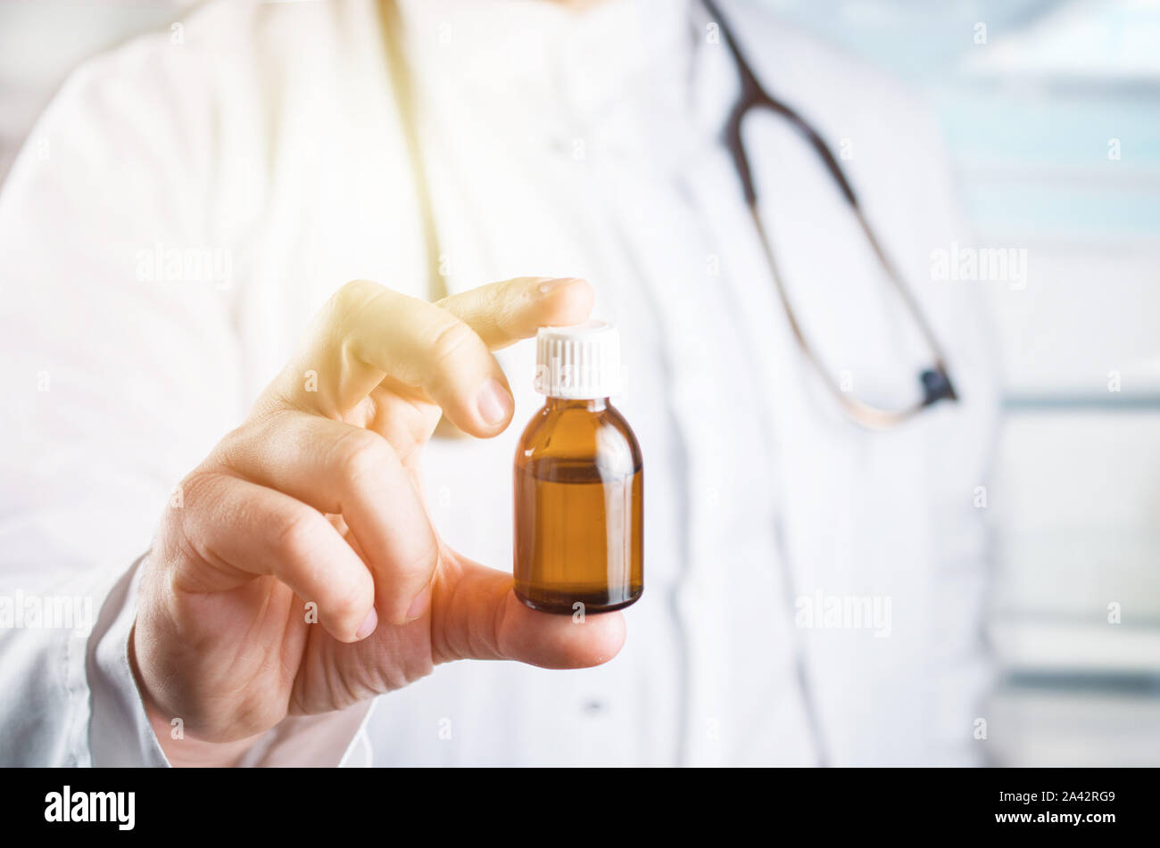 Doctor with a phial with medicine Stock Photo - Alamy