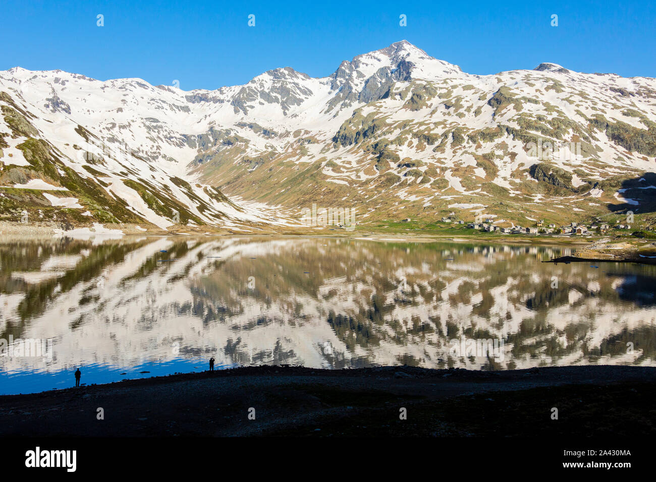 Fishermen on shores of Lake Montespluga at dawn, Valchiavenna, Valle ...