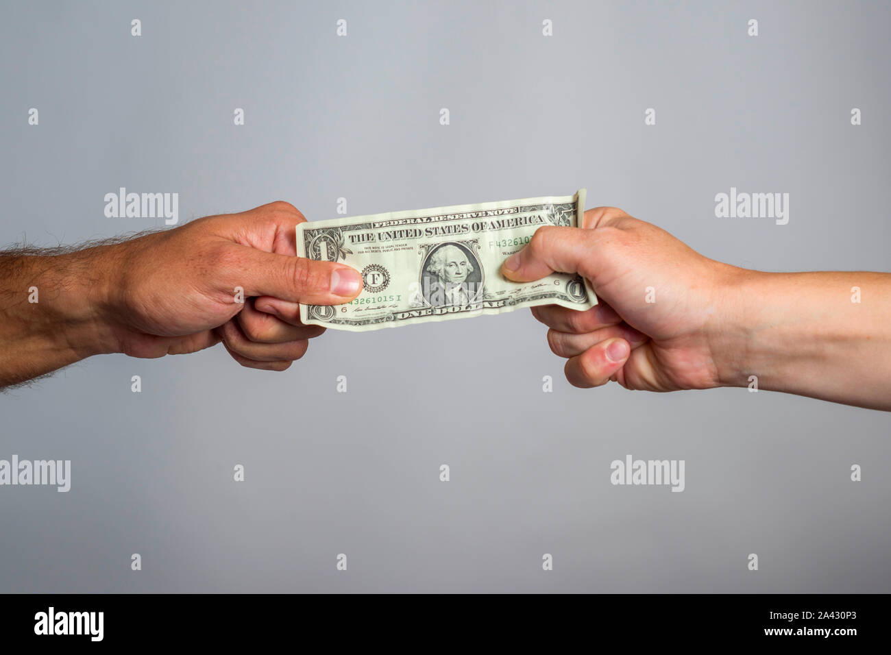 Two hands holding dollar bill. People fighting over money. Financial ...