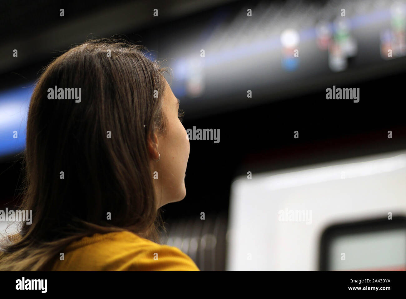 Beautiful young girl dressed in yellow waiting on the subway Stock ...