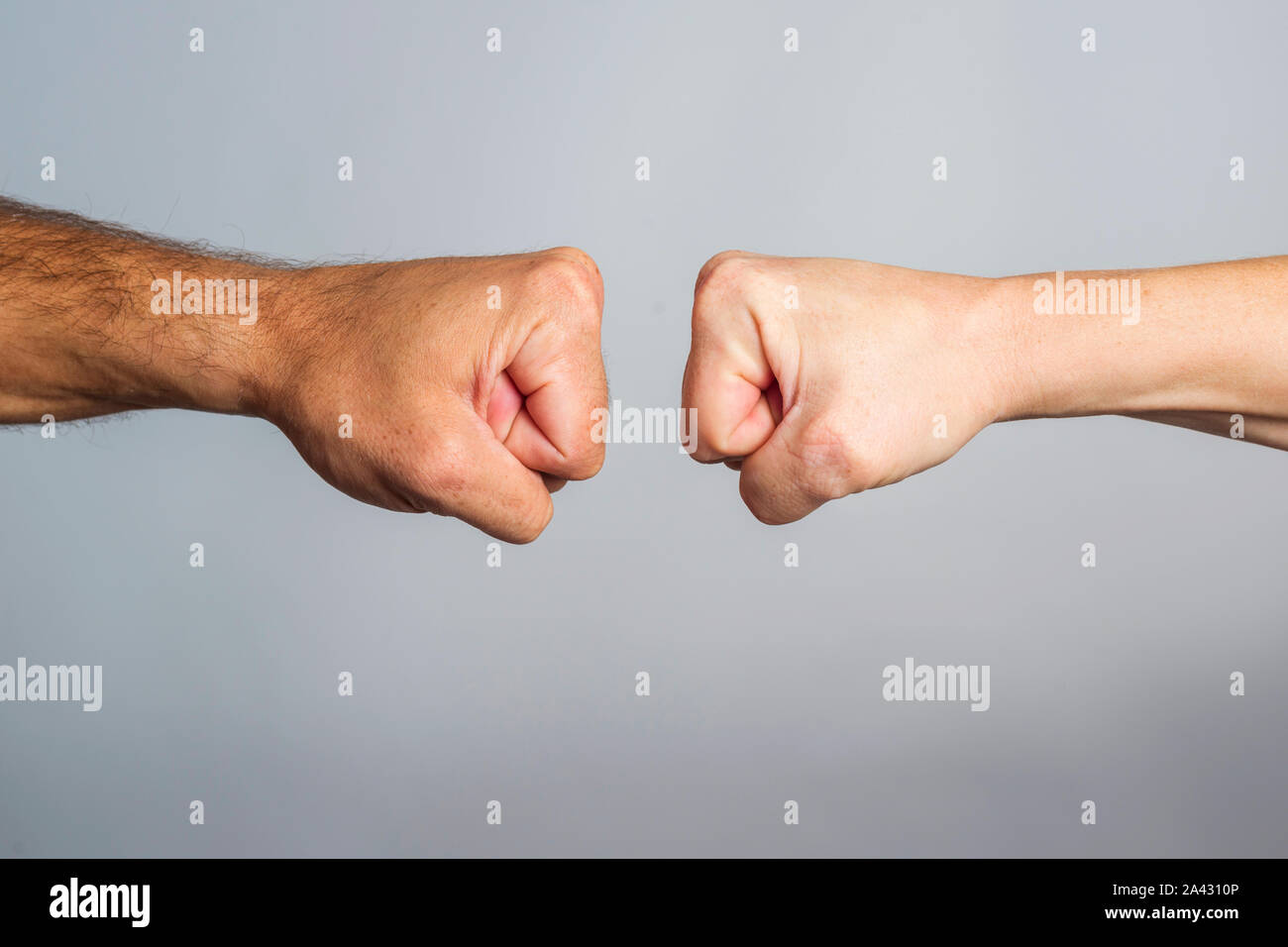 Two male fists hitting each other. Concept of confrontation ...