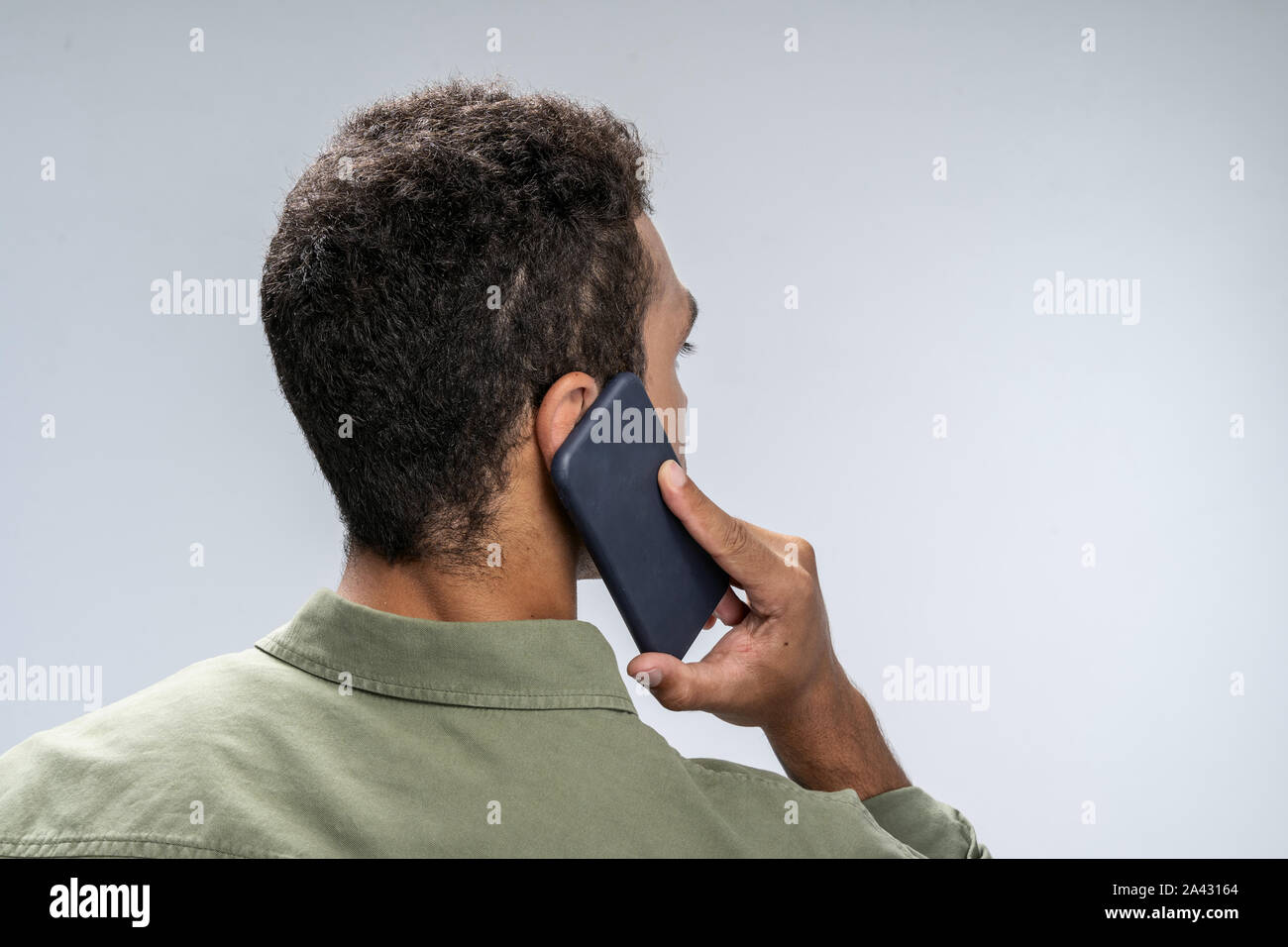 Back view of a handsome male talking on the phone Stock Photo - Alamy