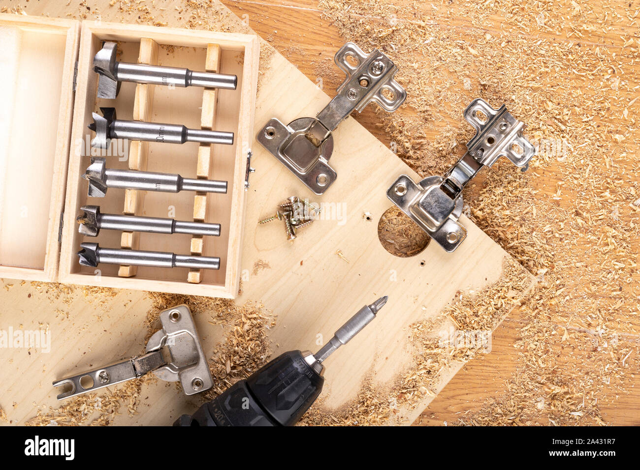 Installation of furniture hinges in chipboard. Small carpentry work in ...