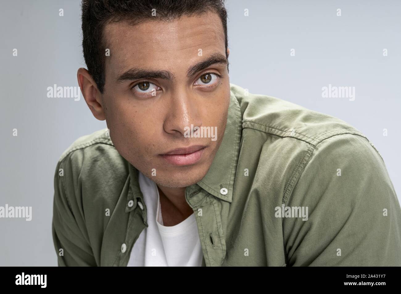 Close up picture of a good-looking young man with serious appearance ...