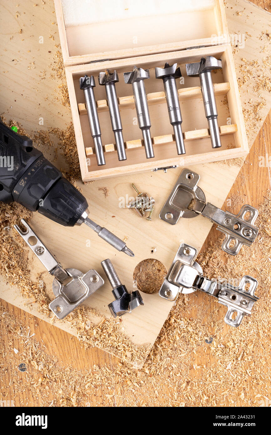 Installation of furniture hinges in chipboard. Small carpentry work in ...