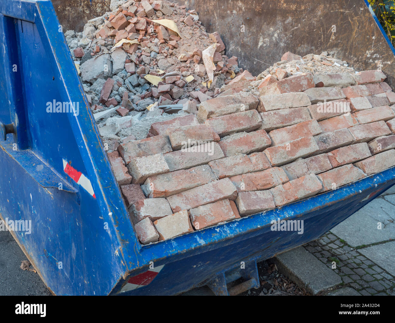 Bricks rubble container Stock Photo - Alamy
