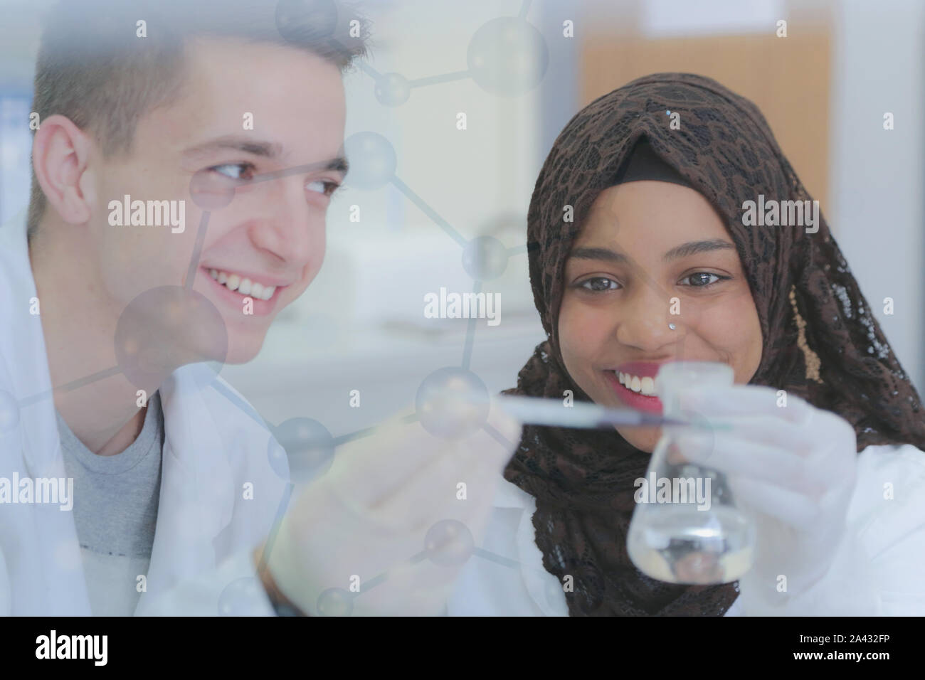 Two young male and female multiethnic, mixed race students scientists ...