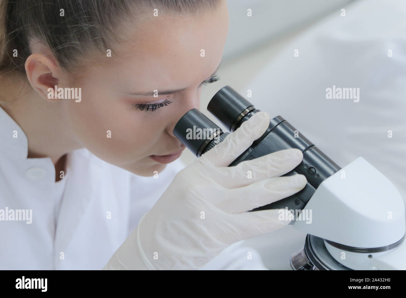 Female scientist looking through a microscope hi-res stock photography ...