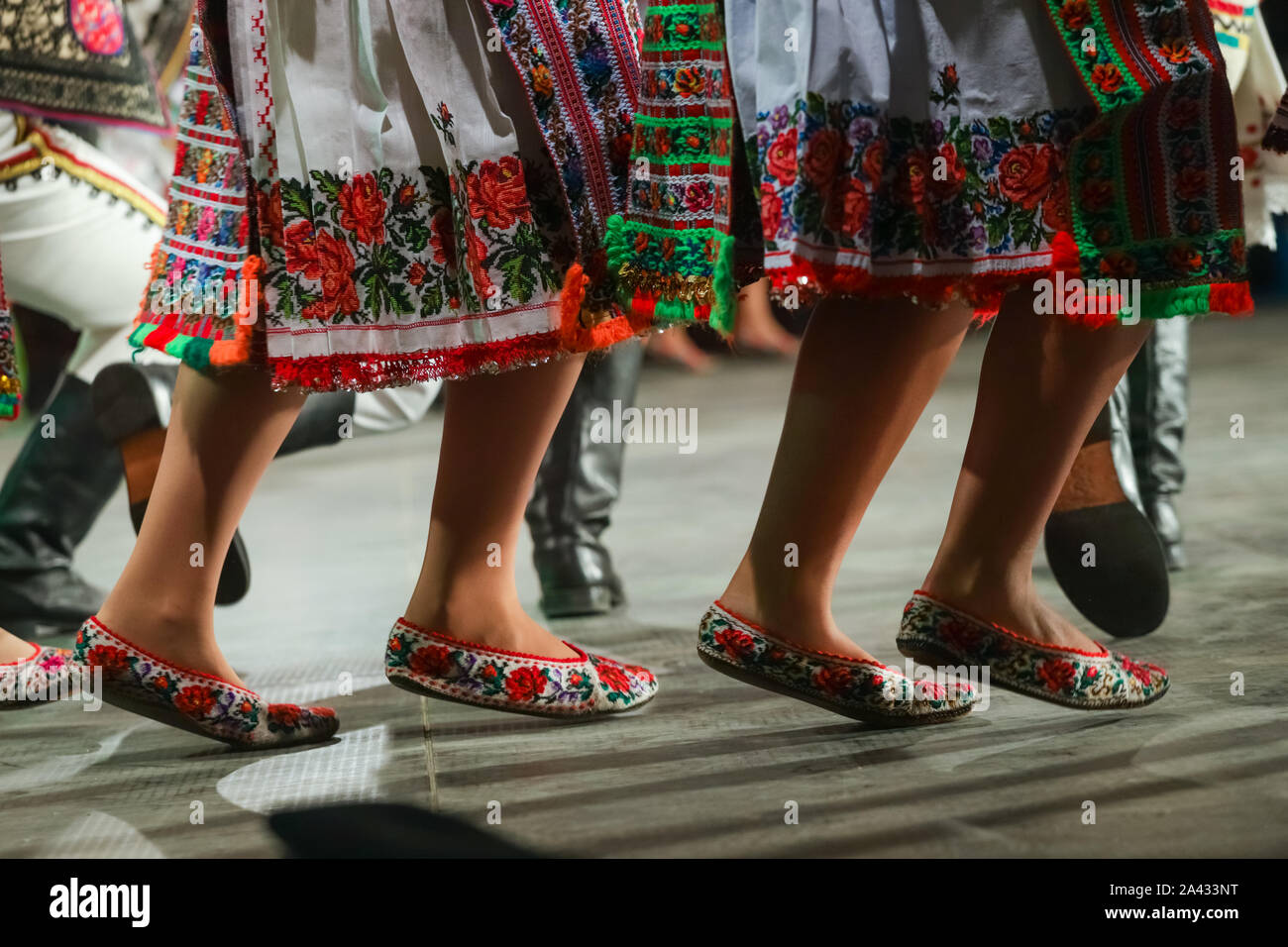 Close up of legs of young Romanian female dancers in traditional ...
