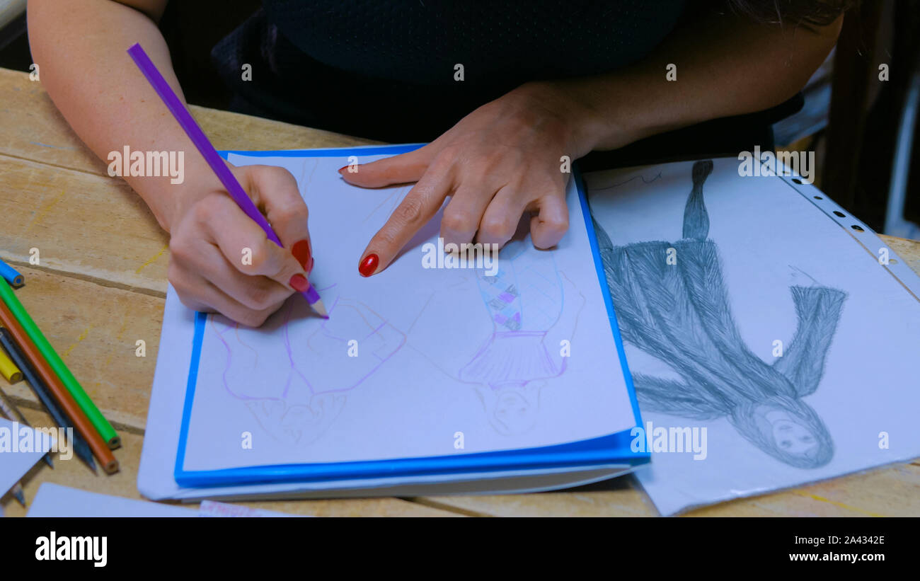 Fashion designer drawing design sketch Stock Photo - Alamy