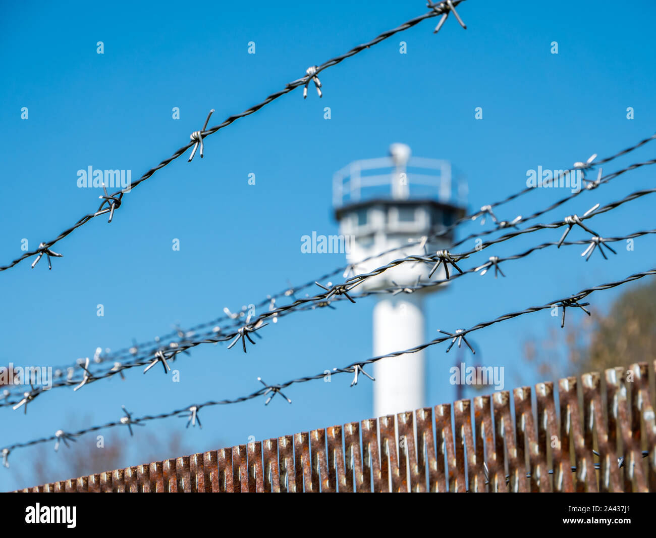 Barbed wire with German watchtower border Stock Photo - Alamy